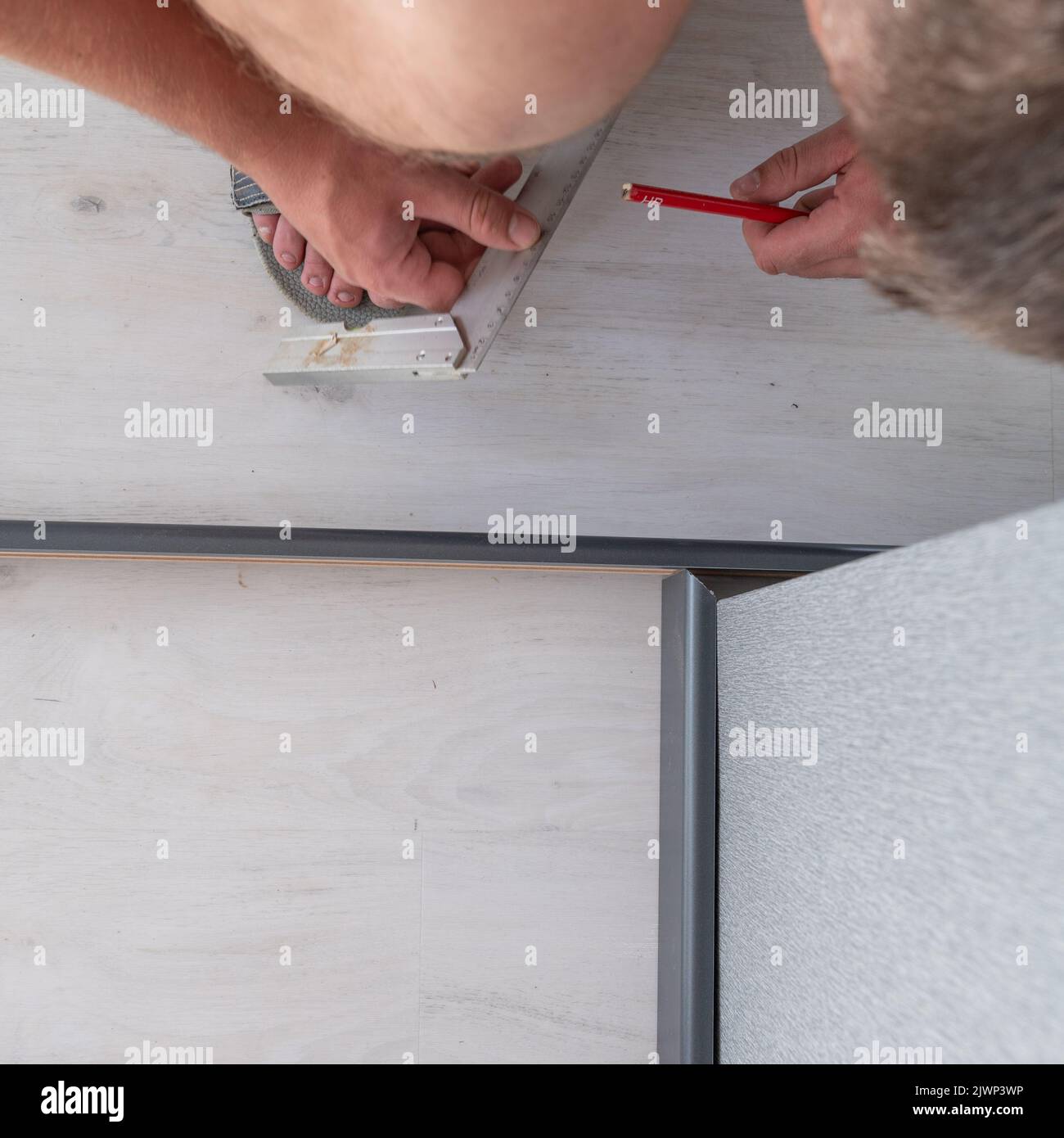 The craftsman measures the length of the plinth for cutting, installing ...