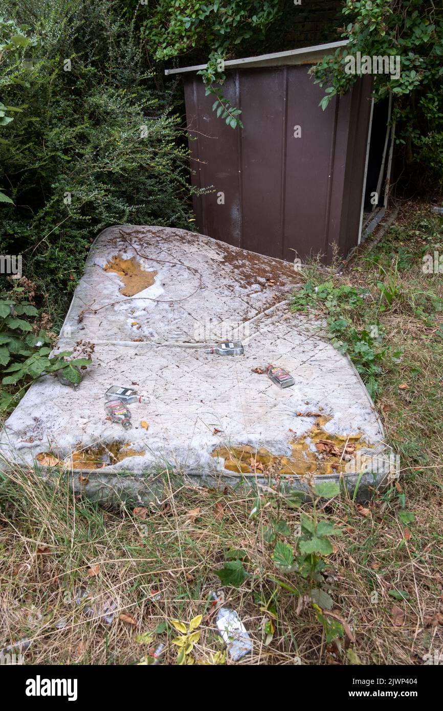 Dumped bed mattress with empty drink bottles (Sep22 Stock Photo - Alamy