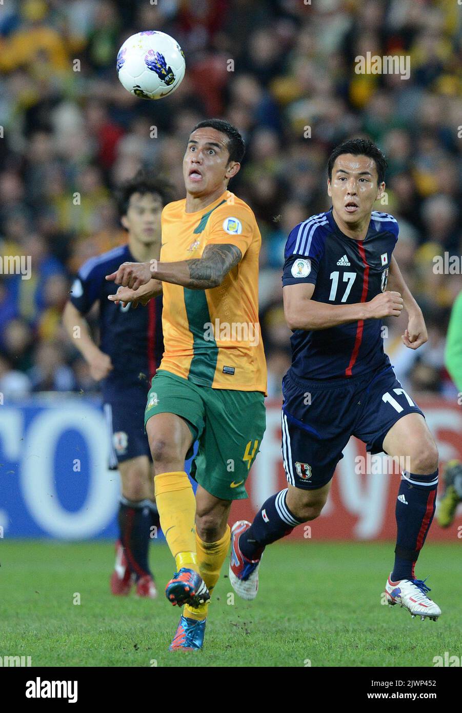 Socceroos player Tim Cahill (L) competes for the ball during the 2014 ...