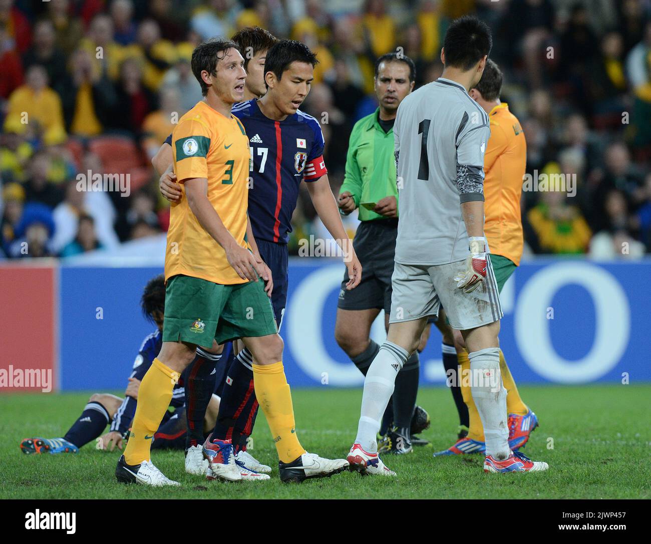 Socceroos player Mark Milligan (L) leaves the field after a red card ...
