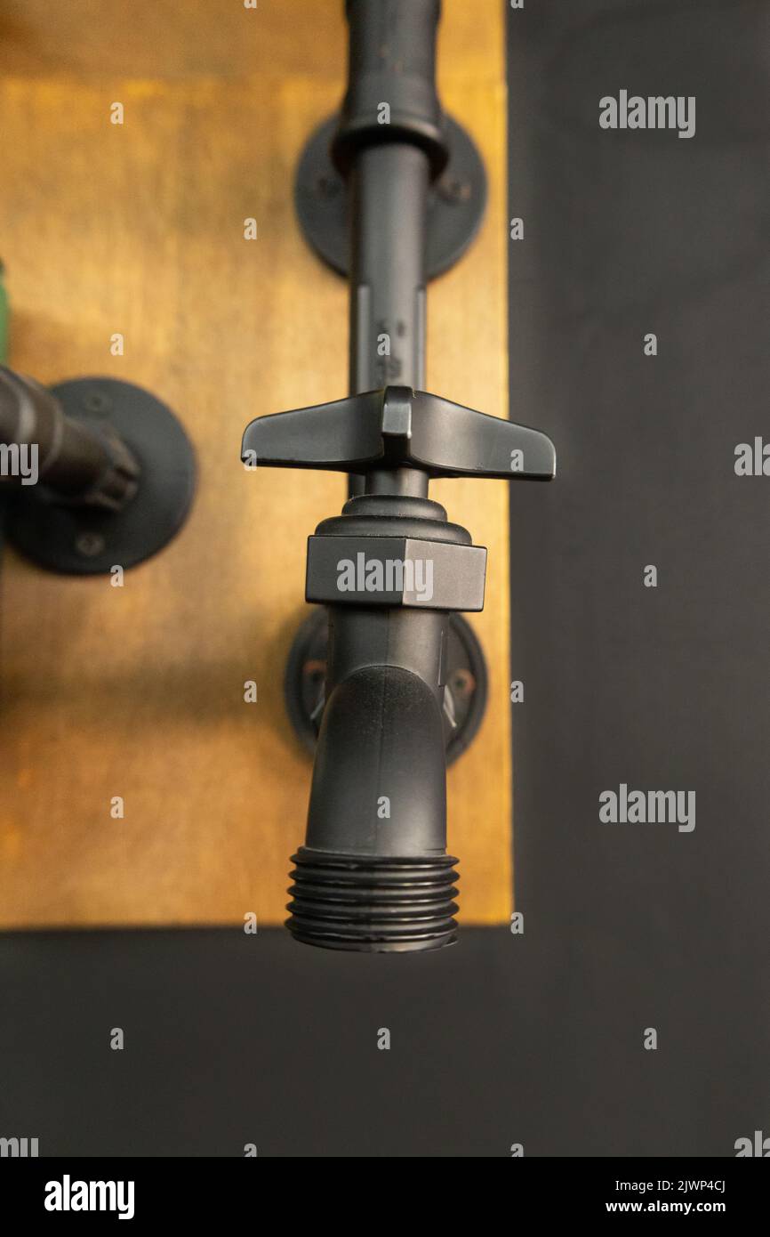details of a metal faucet on a wooden base, texture and design element ...