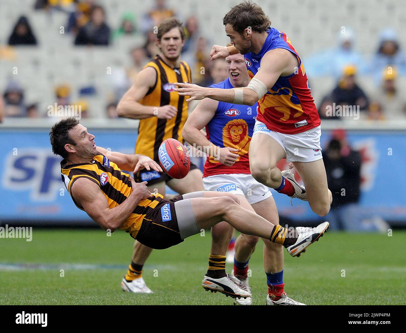 Brent Guerra of Hawthorn collides with Aaron Cornelius of Brisbane ...