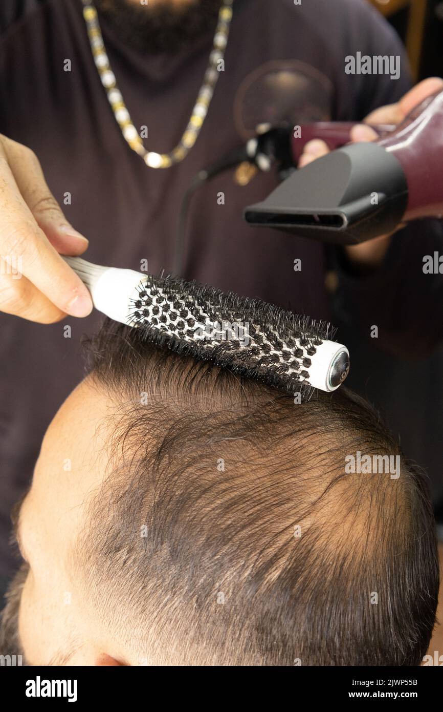 Barber using hair dryer machine hi-res stock photography and images - Alamy