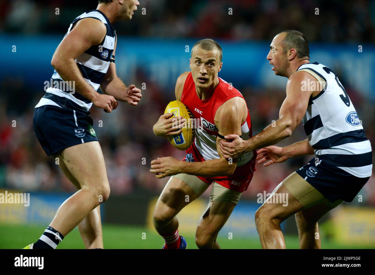 Sydney Swans Ted Richards is tackled by Geelong Cats James Podsiadly ...