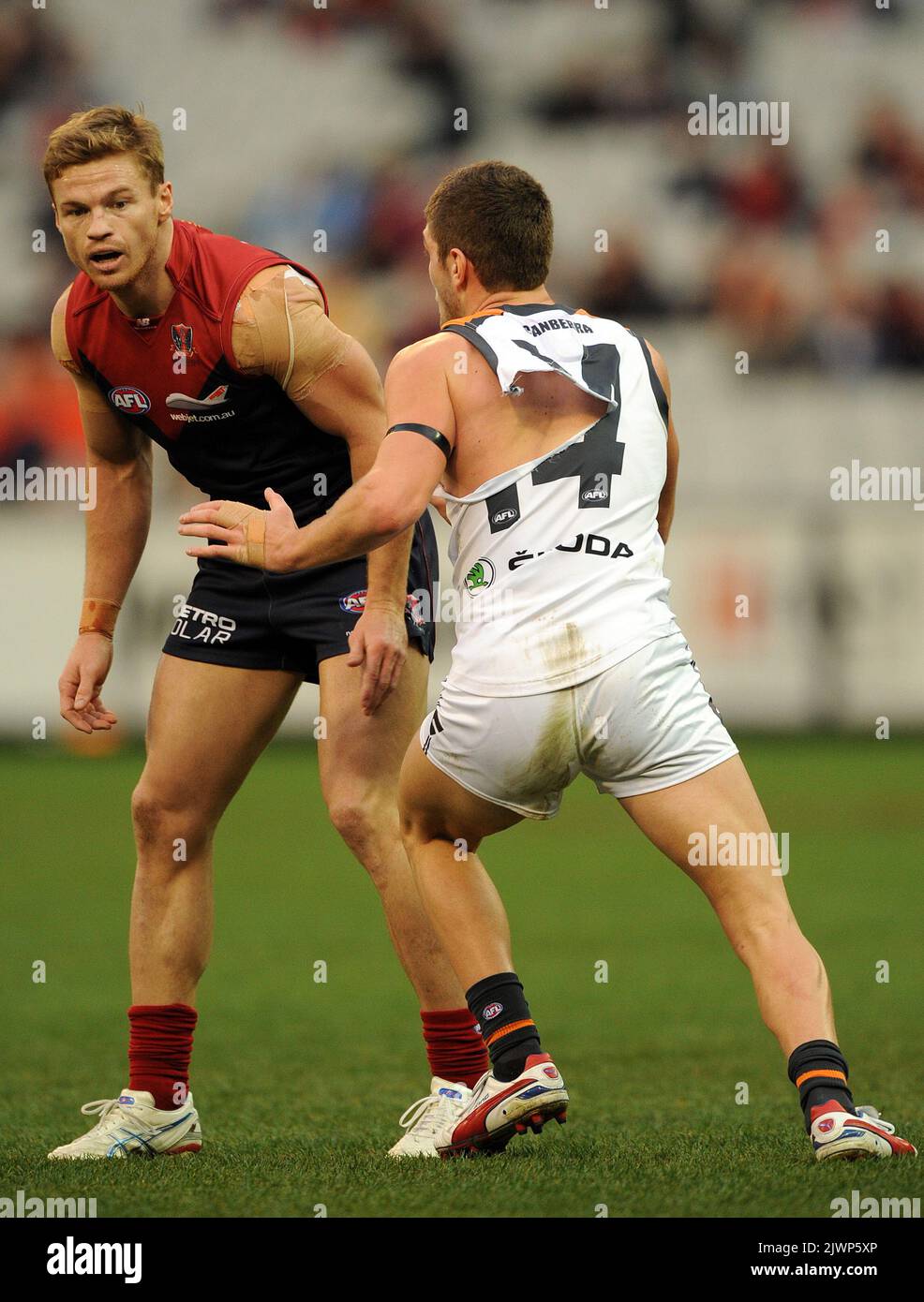 Tomas Bugg GWS Giant plays with a torn shirt next to Colin Sylvia of ...