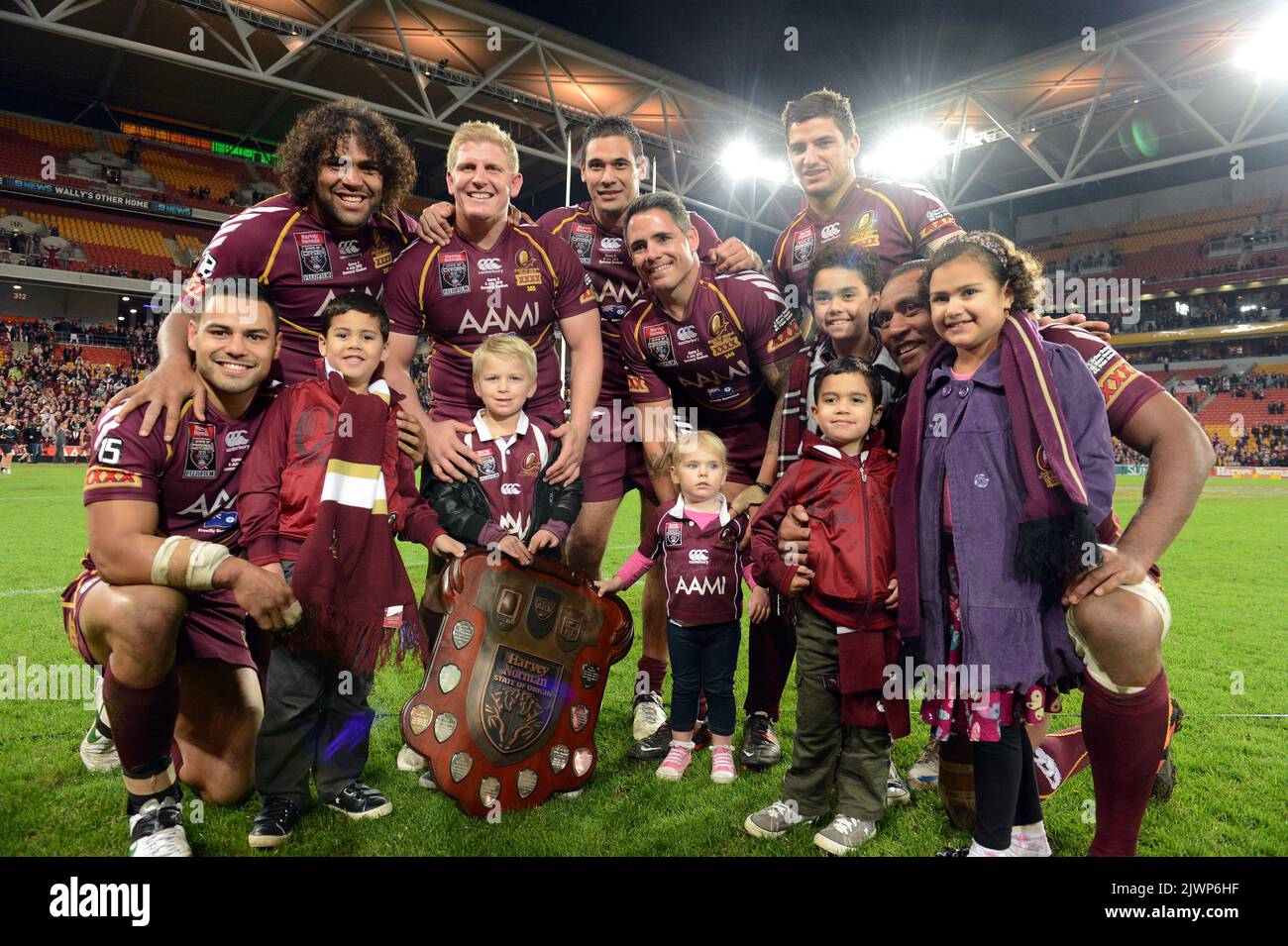 Queensland players pose for photographs with family members following ...