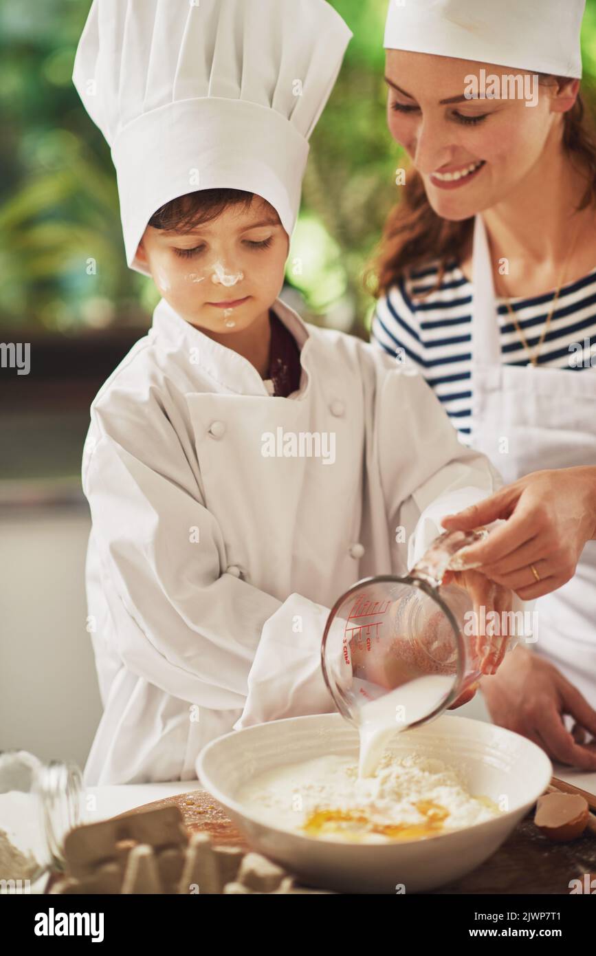 Homemade is the best. a mother and her young son baking together in the ...