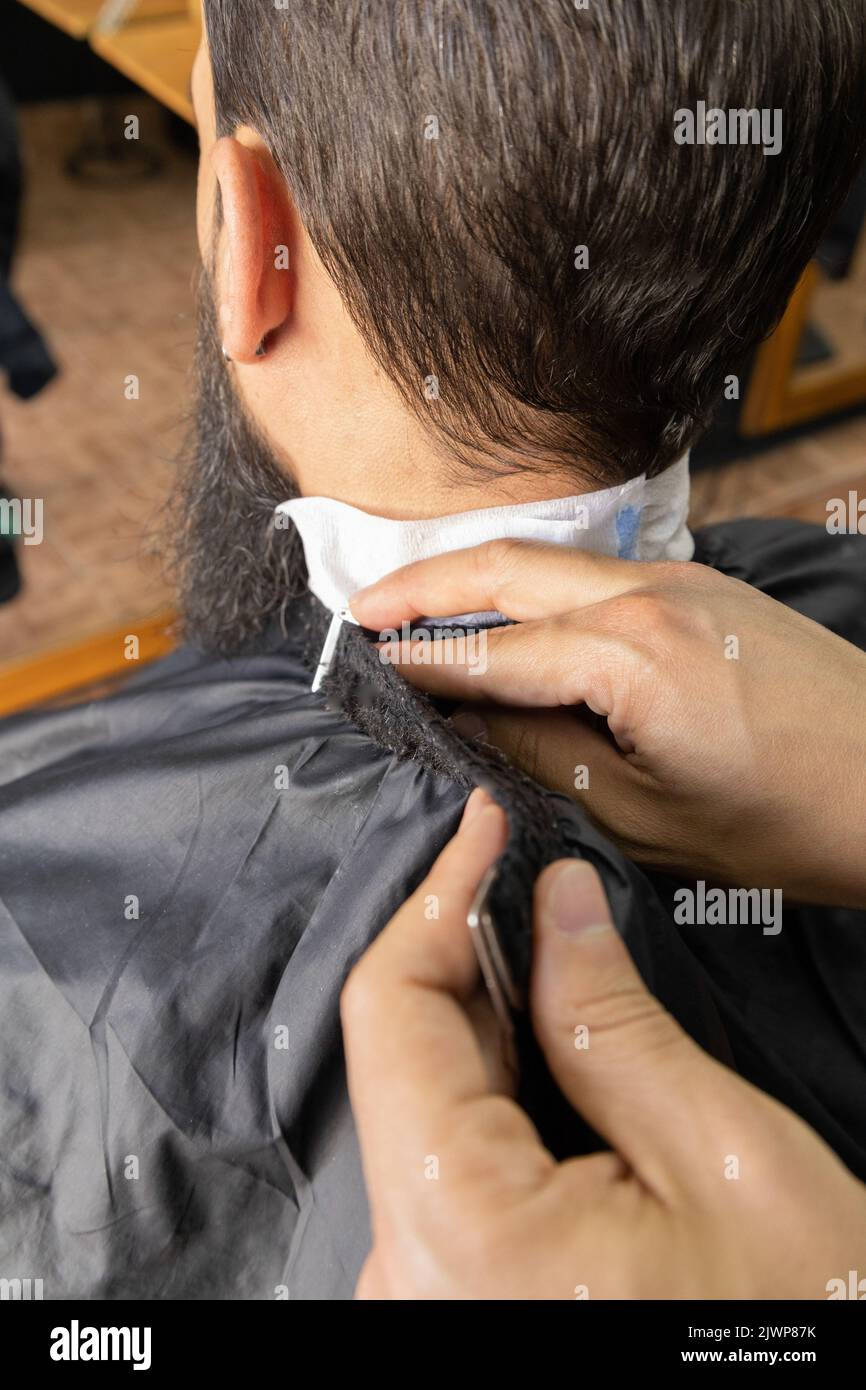 laying down a hairdresser cape for cutting hair, professional ...