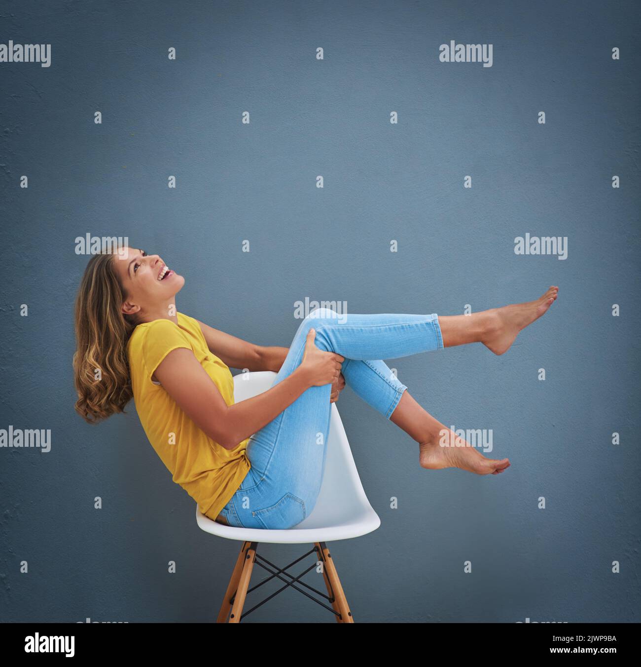 Enjoy the little things in life. a young woman sitting on a chair ...