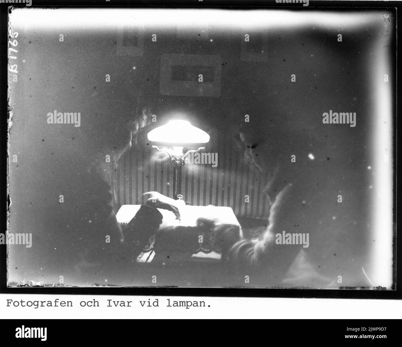 The photographer and Ivar at the lamp. Fotografen och Ivar vid lampan ...