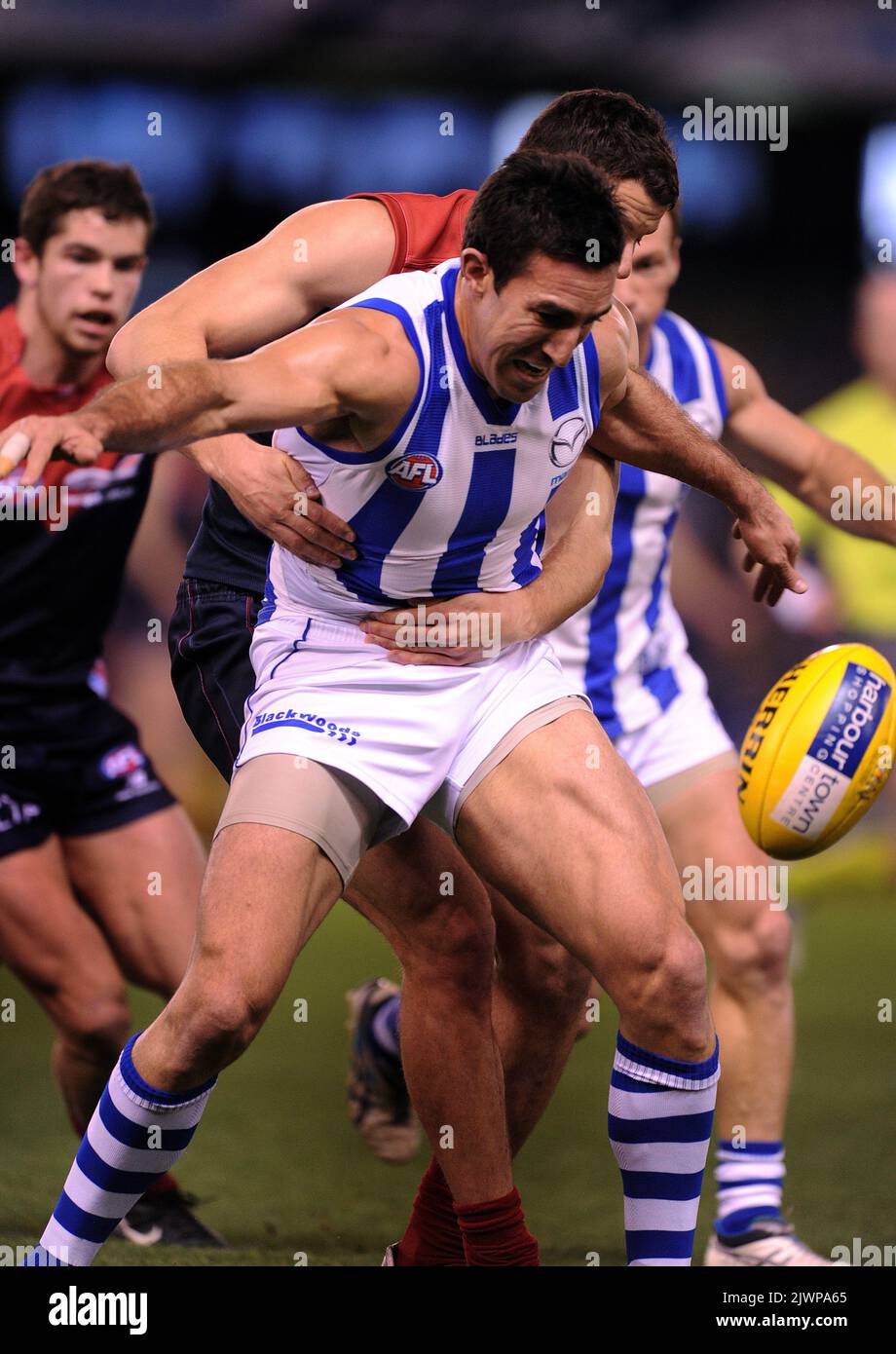 Colin Garland of Melbourne tackles Michael Firrito of North Melbourne ...