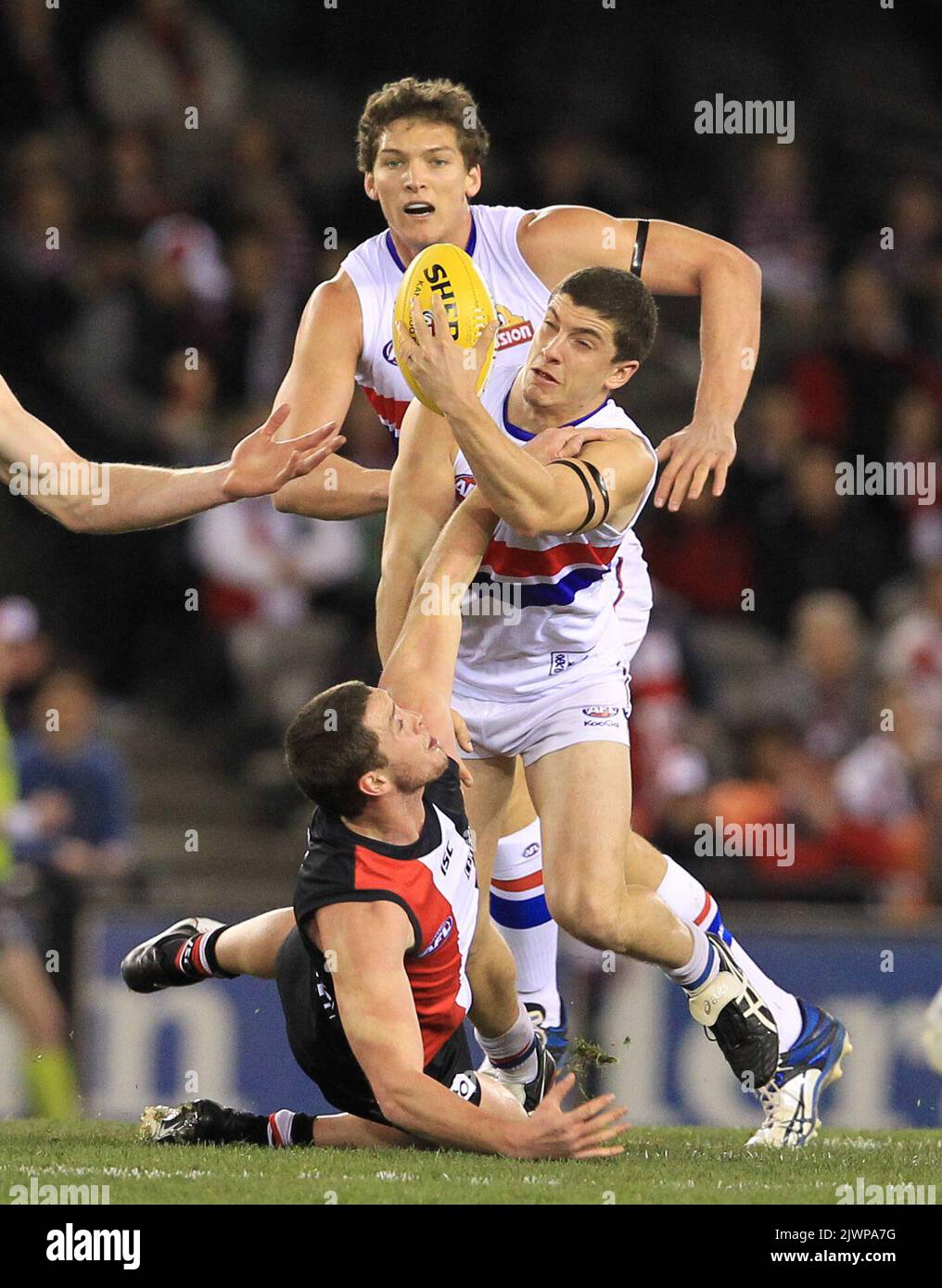 Tom Liberatore goes for the ball for the Bulldogs over the top of Jack ...