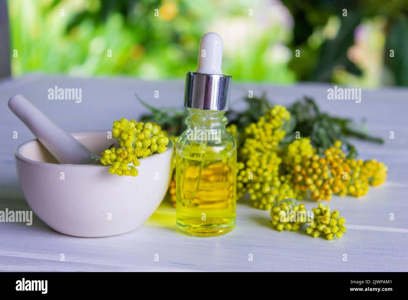 essential oil of tansy in a beautiful bottle on the table. selective ...