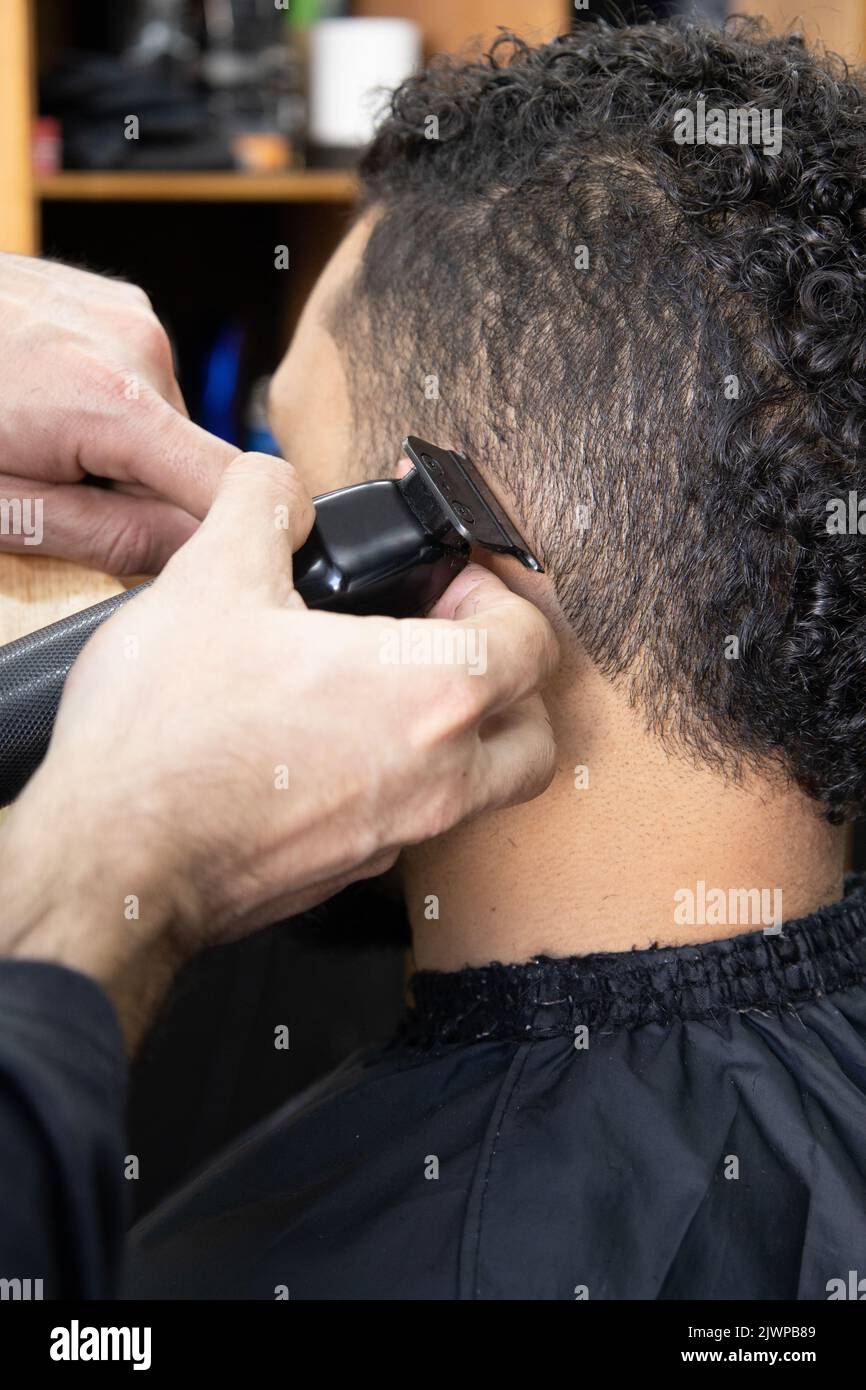 working in a barbershop, shaver for a buzz cut haircut, beauty and ...