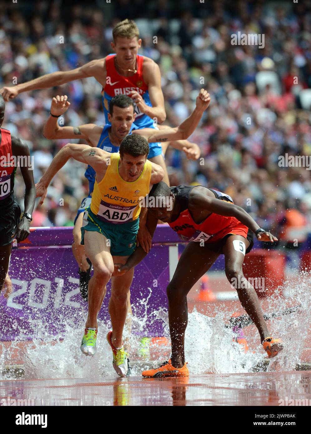 Australia's Youcef Abdi (left) and Jacob Araptany of Uganda compete through a water jump during ...