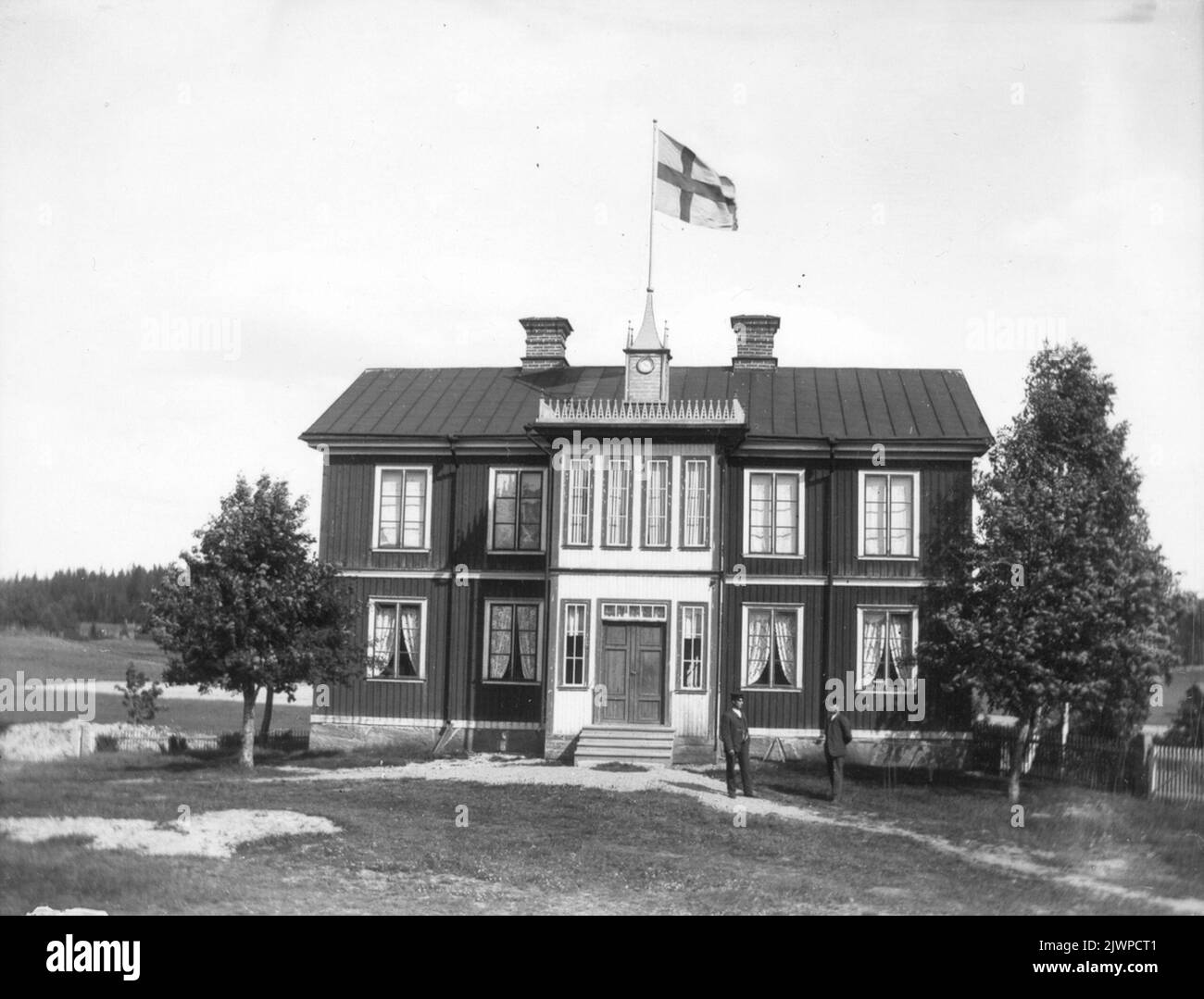 House with tower and Swedish flag on the roof. Hus med torn och svenska ...
