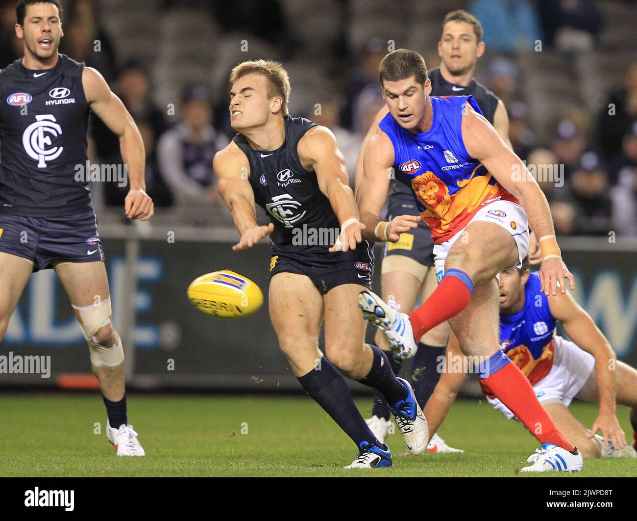 Jonathan Brown kicks a goal for Brisbane as Matthew Watson tries to ...