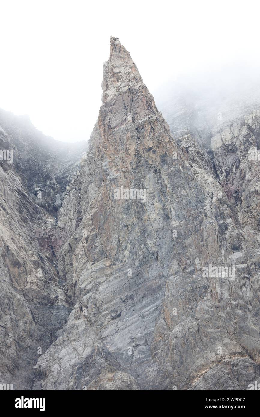 foggy alpine mountainside with rocks and clouds side by side Stock ...