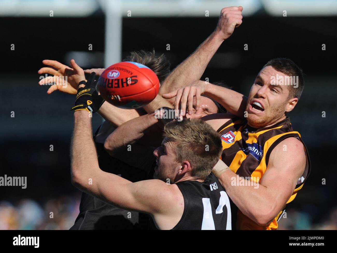 Max Bailey of Hawthorn (far right) challenges for the ball againsts ...