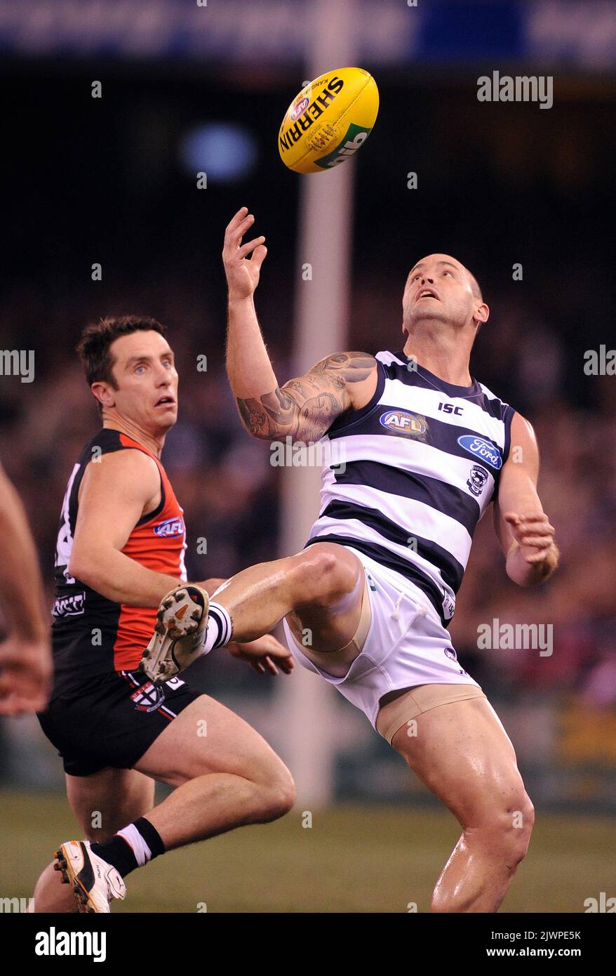 Stephen Milne of St Kilda watches as Josh Hunt of Geelong takes a mark ...