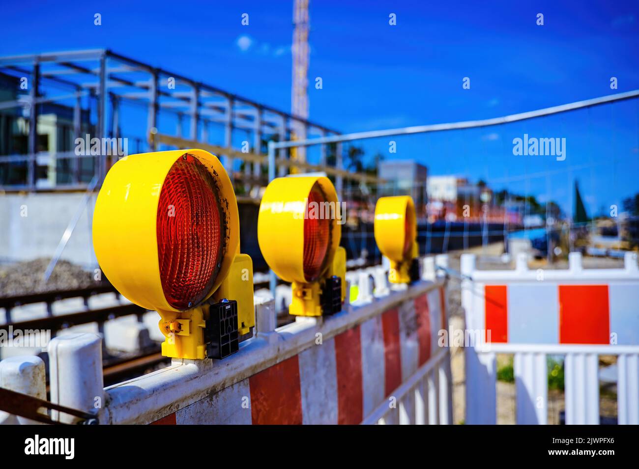 Warning lights on a barrier in front of the construction site for a new ...