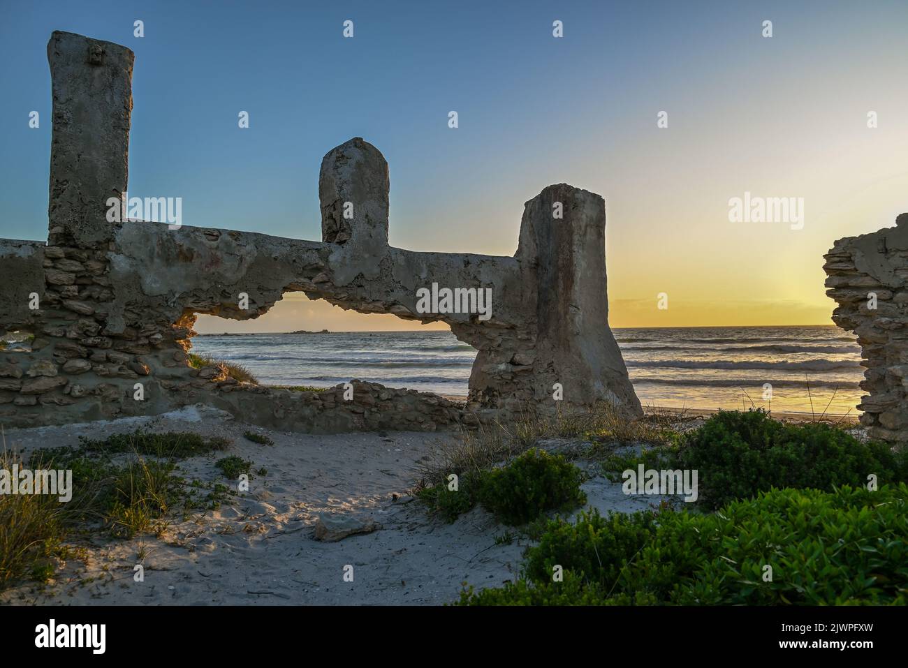 Sunset on beach with ruins 2 Stock Photo - Alamy
