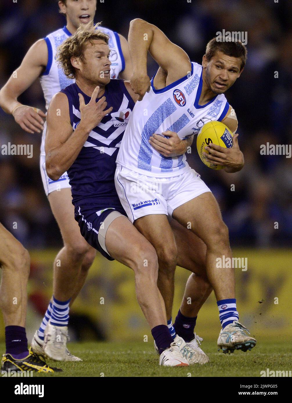 Cruize Garlett of North Melbourne gets tackled by Paul Duffield of ...