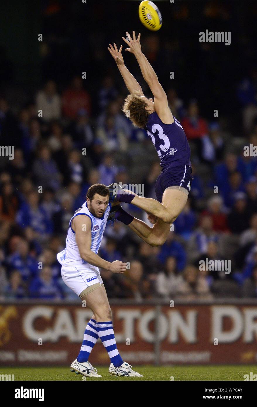 Chris Mayne of Fremantle attempts a big mark over Scott McMahon of ...