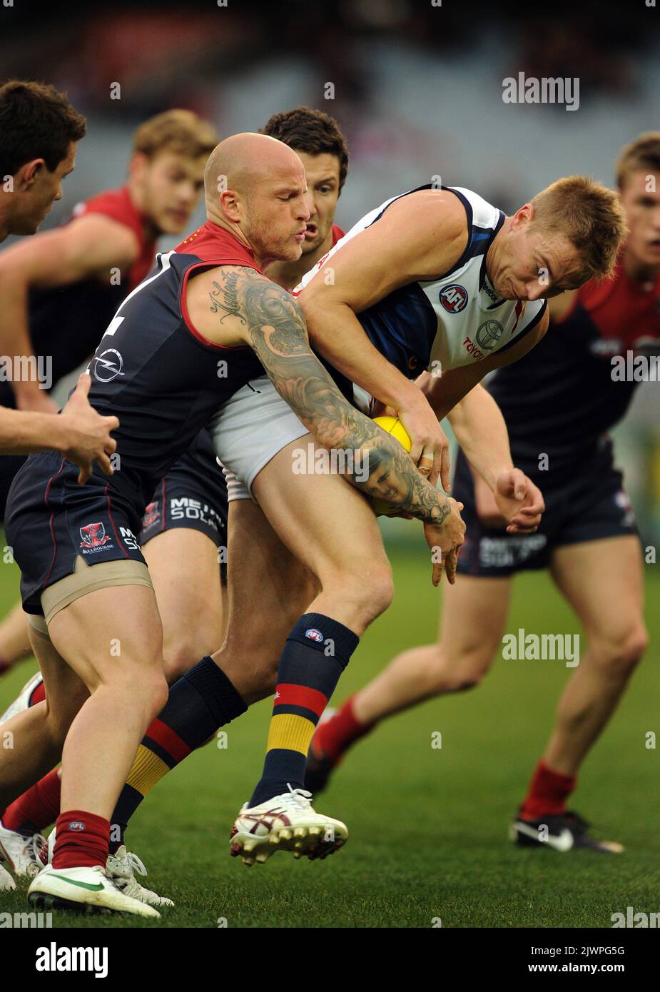 Nathan Jones of Melbourne tackles Bernie Vince of Adelaide, during ...