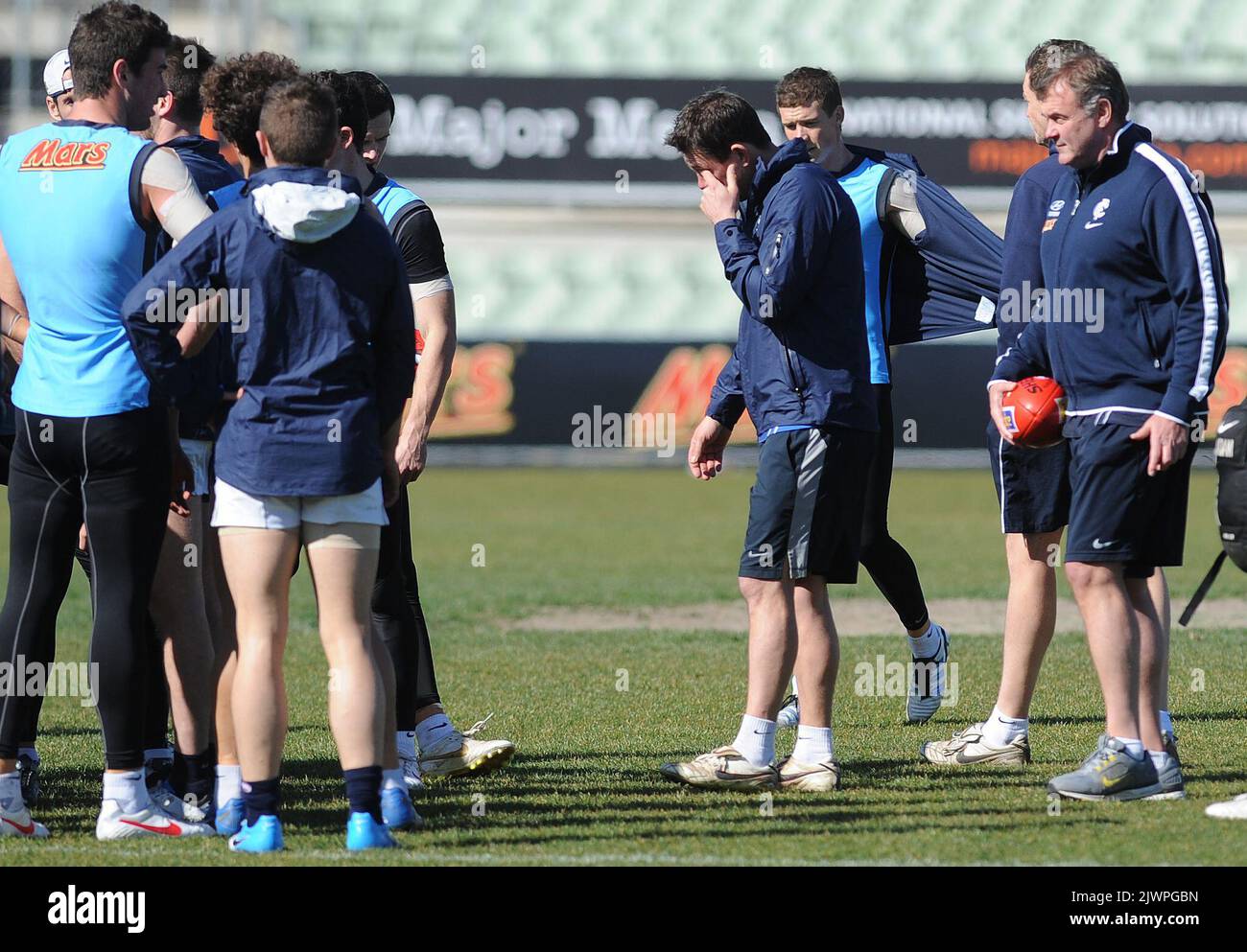 Carlton coach Brett Ratten (fourth from right) wipes his eye during ...
