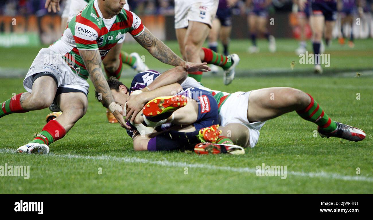 Billy Slater slides through the tackle of Nathan Peats to score during ...