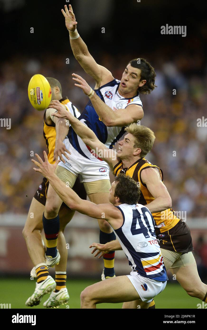 A pack of Hawthorn and Adelaide players in action during their First ...