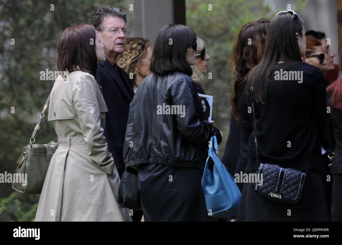 Mourners, including ABC radio show host Red Symons (second from left ...