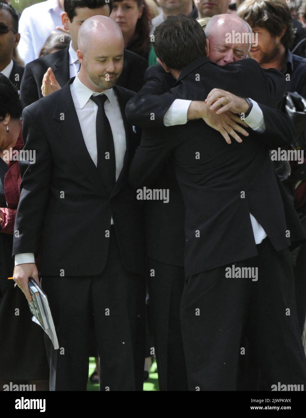 The father of Jill Meagher, George McKeon (right) hugs her husband Tom ...