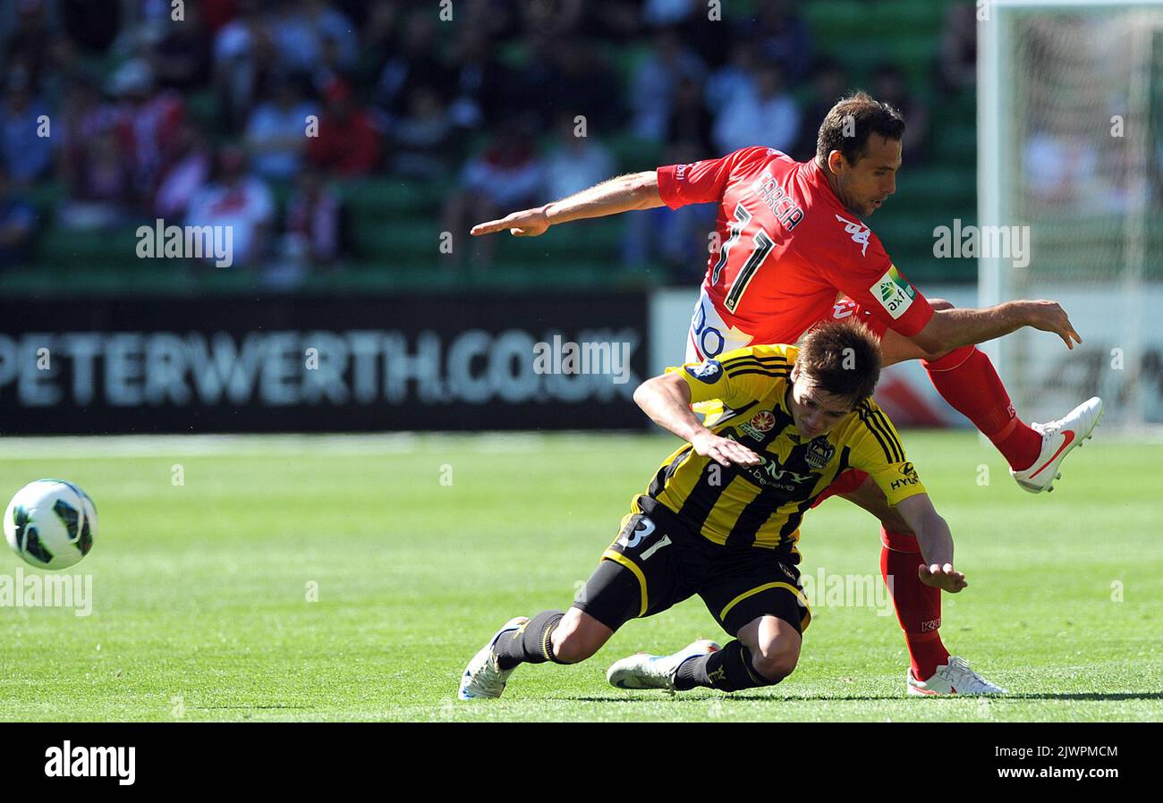 Tom Biss of the Wellington Phoenix contests the ball against Richard ...
