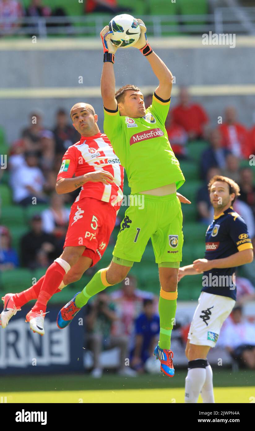 Mariners goal keeper Mathew Ryan jumps for the ball in front of Fred in ...