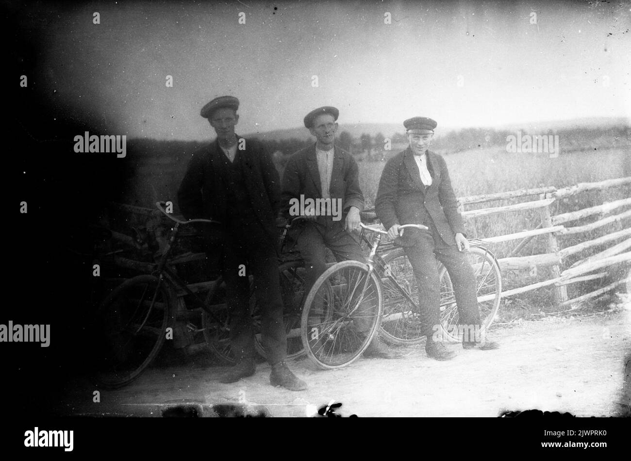 Three men with the bike Black and White Stock Photos & Images - Alamy