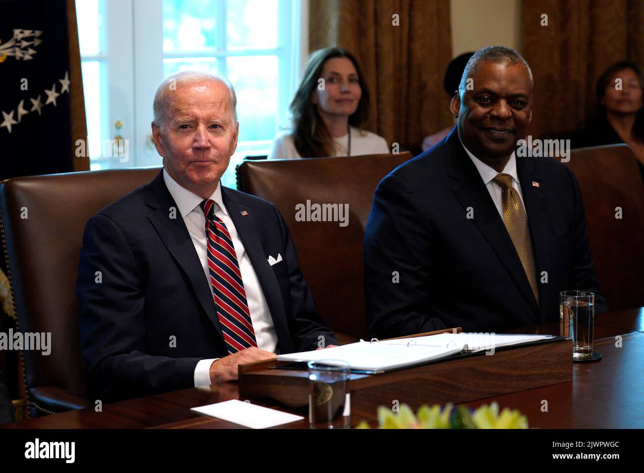 US President Joe Biden (L) with Defense Secretary Lloyd Austin holds a ...