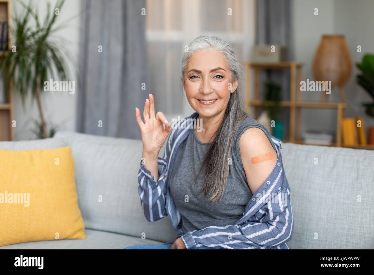 Smiling senior european gray-haired woman show ok sign with hand and ...