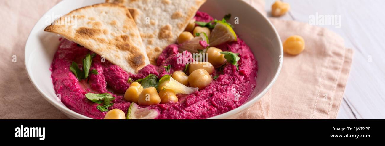 Close-up of Beetroot hummus on white table Stock Photo - Alamy