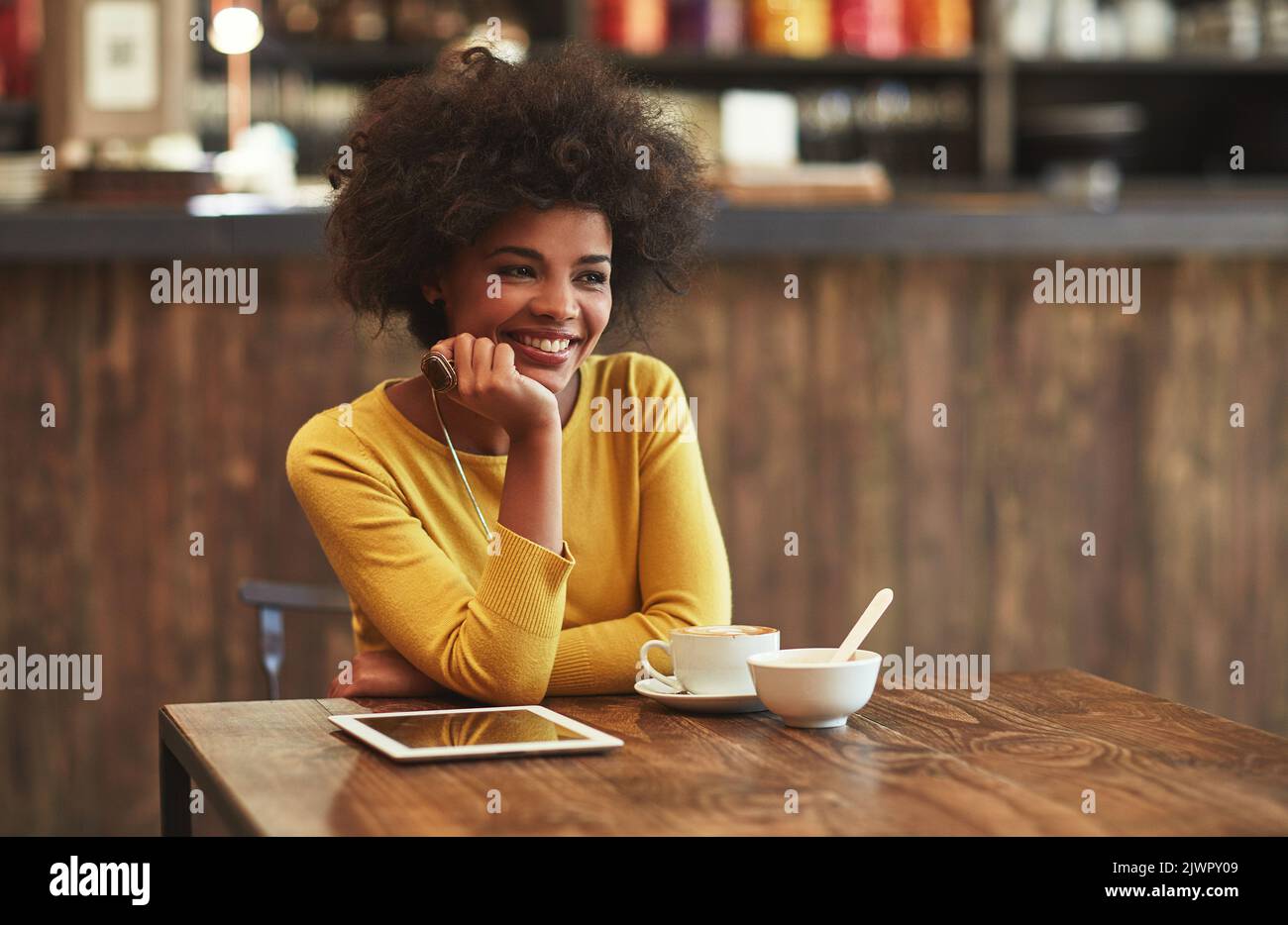 Her first stop is the local coffee shop. Portrait of a young woman ...