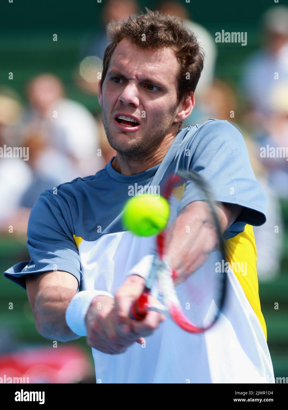 Paul-Henri Mathieu of France hits a backhand return in the first round ...
