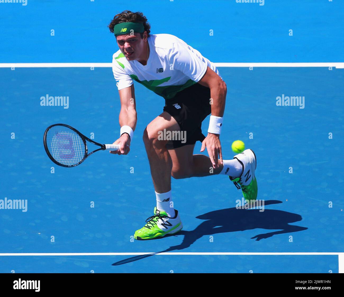 Milos Raonic of Canada plays a forehand volley in the second round ...