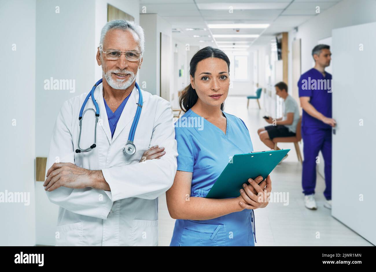 Portrait of happy medical team standing in hospital corridor after hard working day. medical ...
