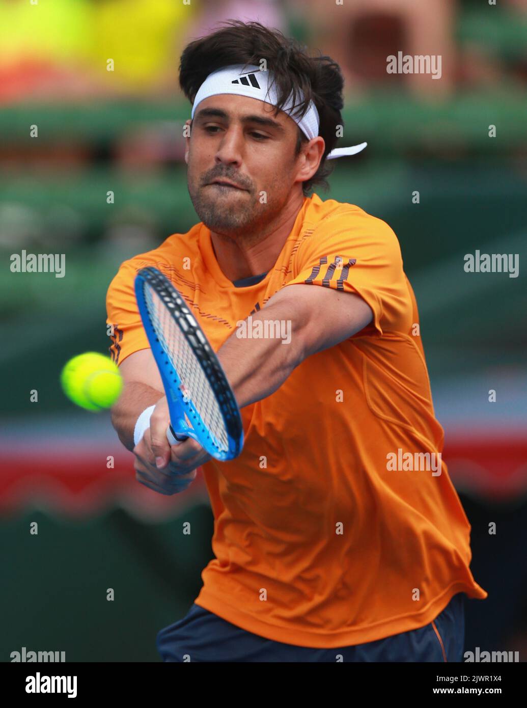Marcos Baghdatis of Cyprus plays a backhand return in the third round ...