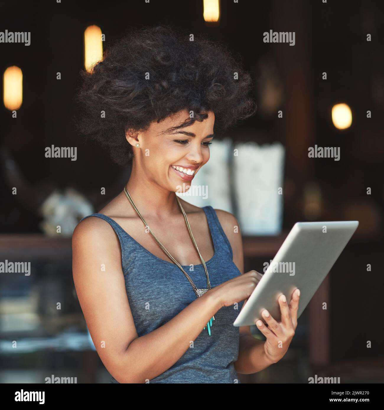 Managing her cafe with the handiest apps. a young woman using a digital ...