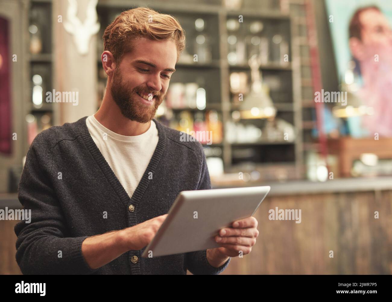Connected to the coffee shop network. a young man using a digital ...