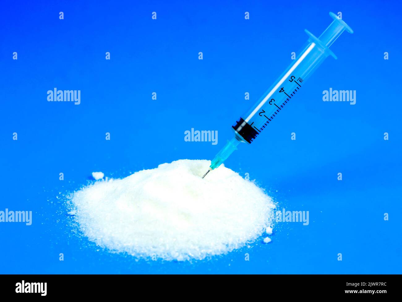Conceptual photo of syringe and sugar emulating sugar addiction Stock ...