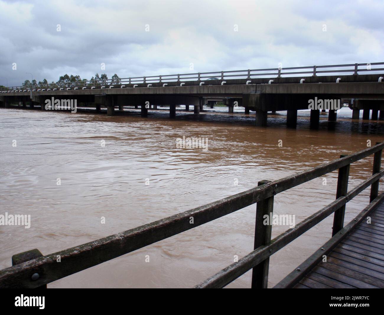 Swollen by heavy rains, the Coomera River flows underneath the Pacific ...