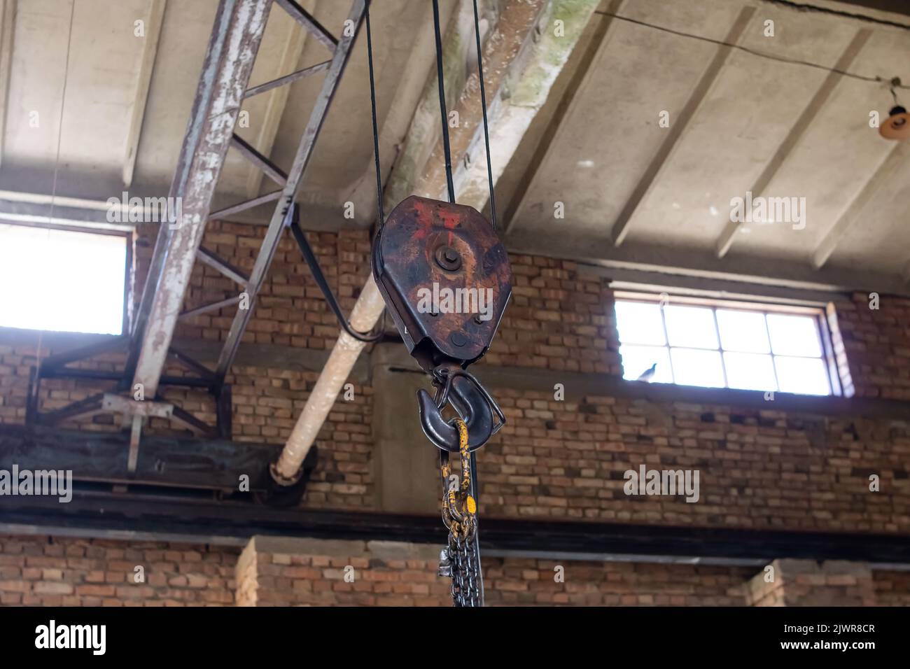 Large rusty hook under the ceiling in an old building close up Stock ...